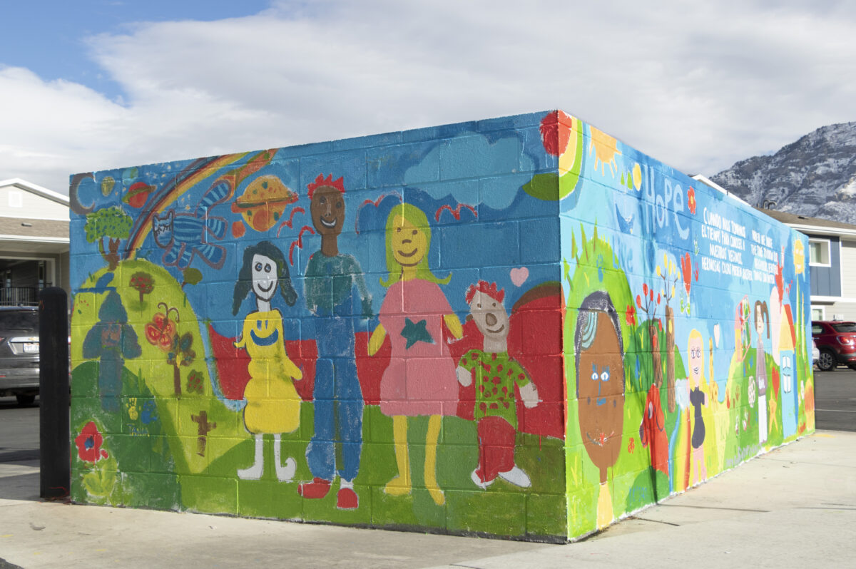 Artists brighten up neighborhood through colorful mural, with kids ...
